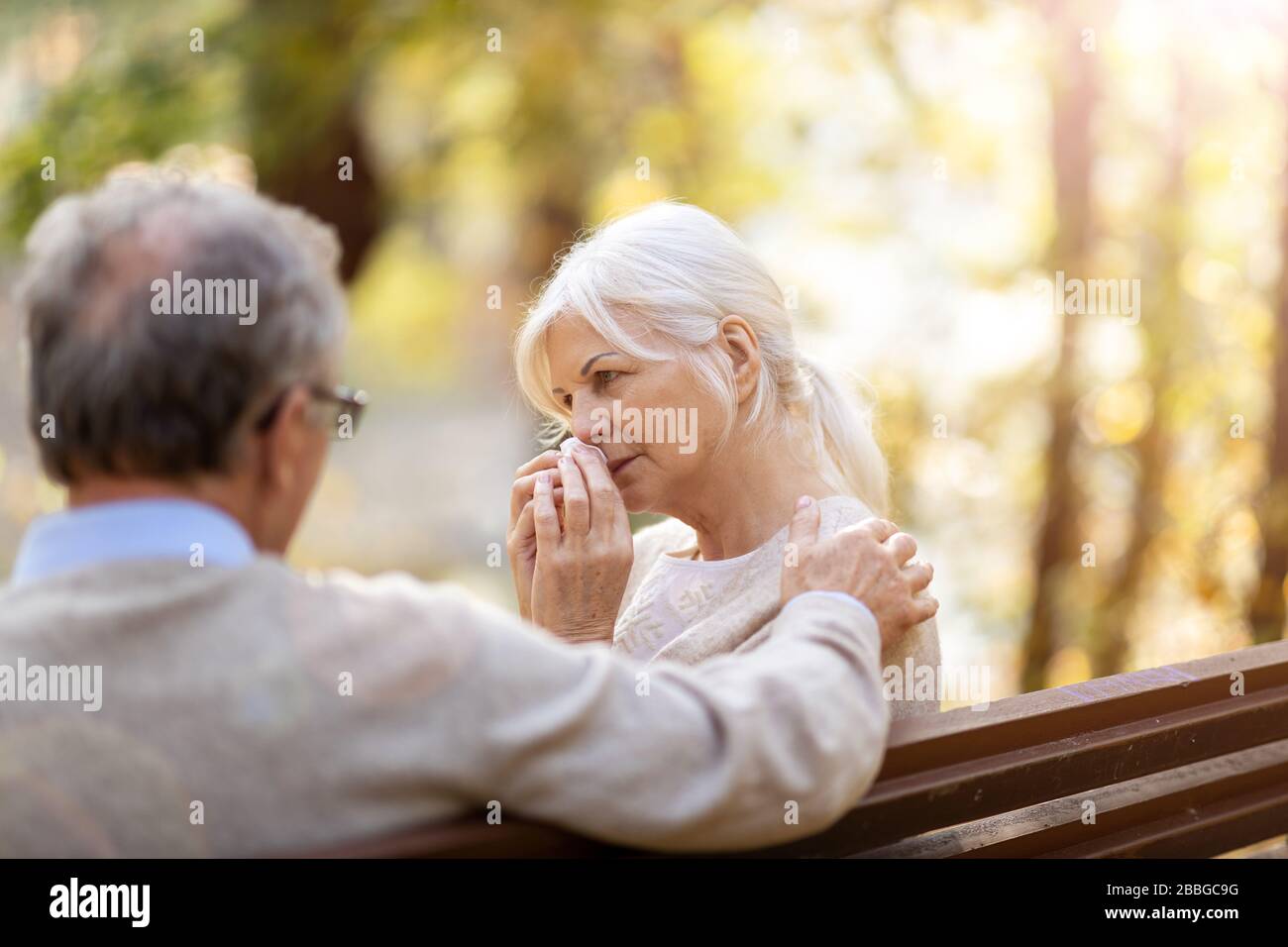 Depressed senior woman consoled by elderly man Stock Photo - Alamy