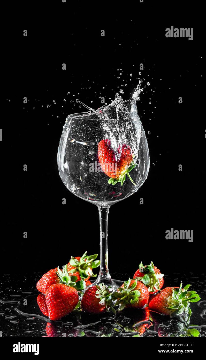 Strawberry splashing in water Stock Photo - Alamy