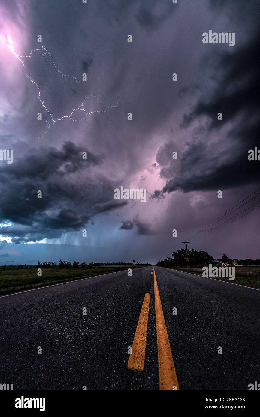 Storm with lightning striking over highway road in rural North Dakota ...