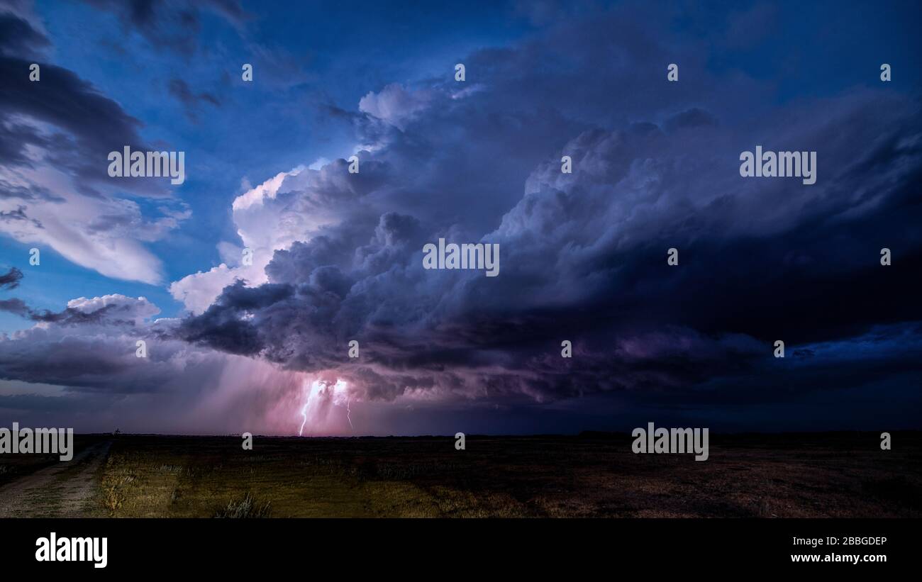 Storm with lightning flashing over field in rural southern Manitoba ...