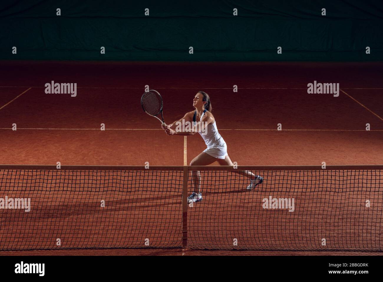 Young caucasian professional sportswoman playing tennis on sport court ...