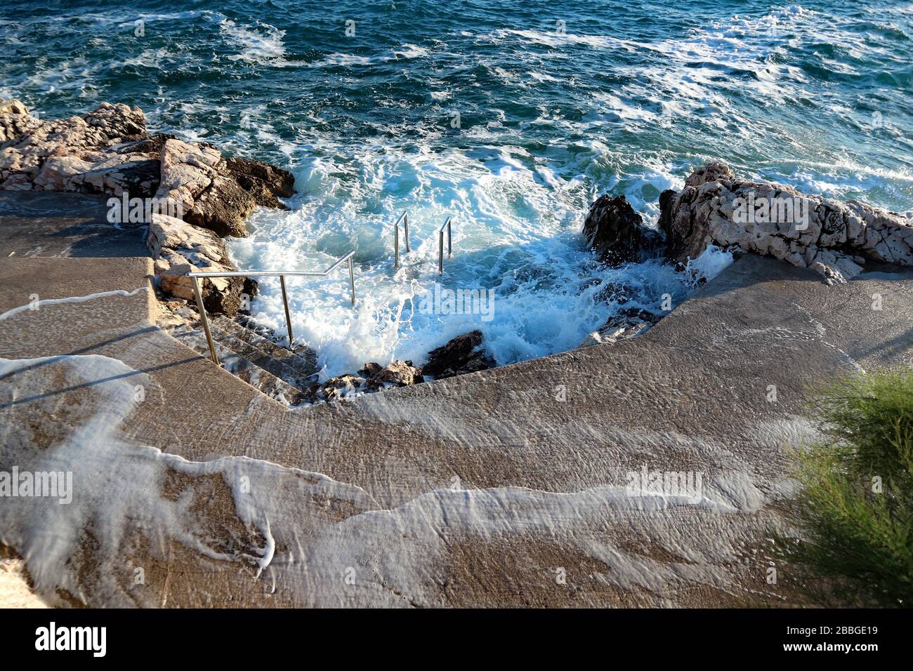 Strong waves hitting the city beach on croatian coast Stock Photo - Alamy