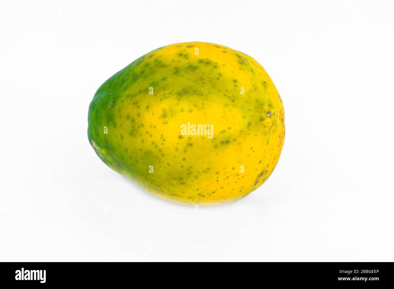 Photograph of a fresh green yellow medium sized papaya fruit isolated ...