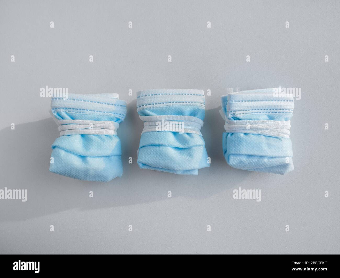 Used mask concept. Three folded used protective face mask isolated on ...