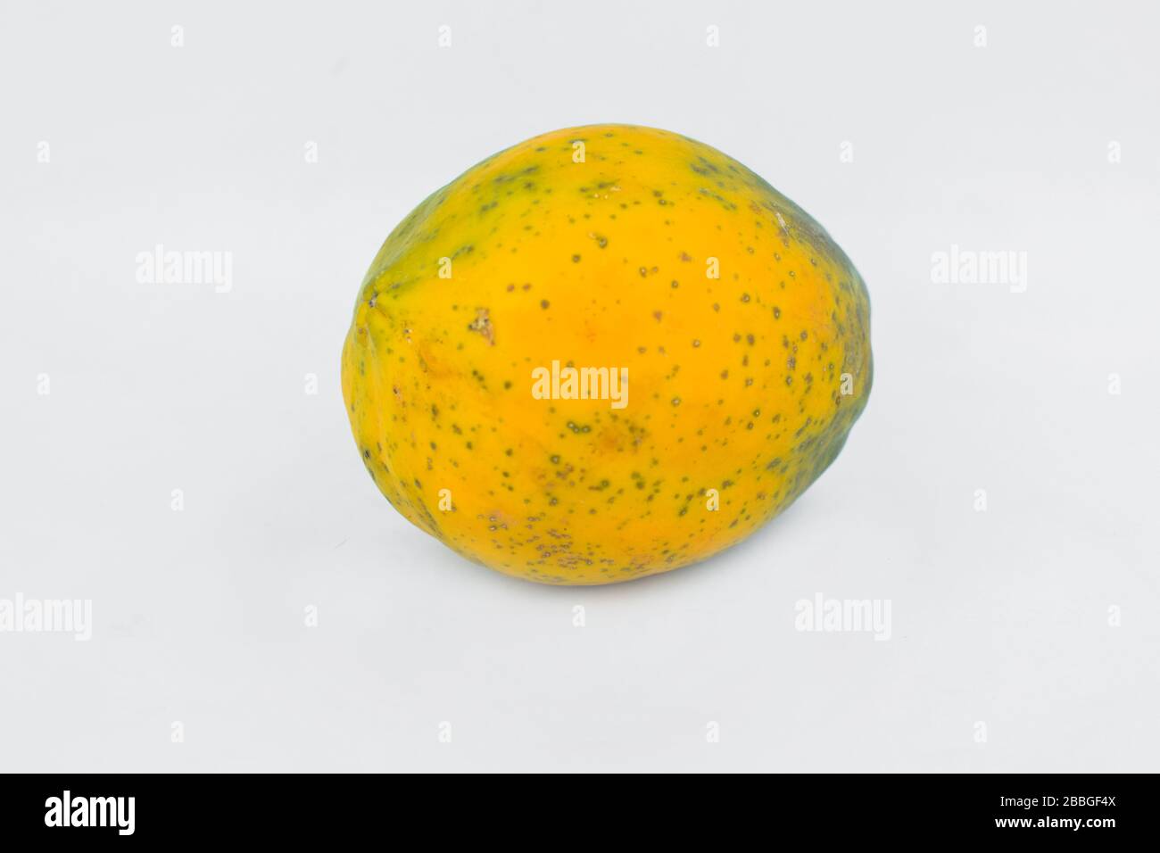 Portrait of a fresh yellow medium sized papaya fruit isolated on an ...