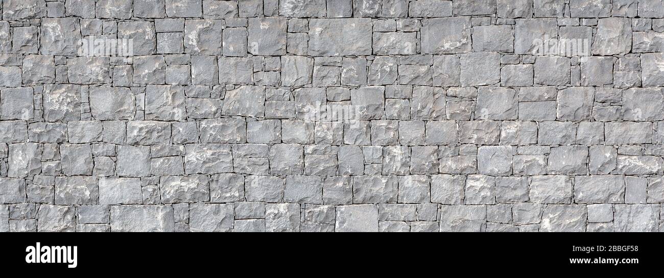 irregular natural stone wall (textured background Stock Photo - Alamy