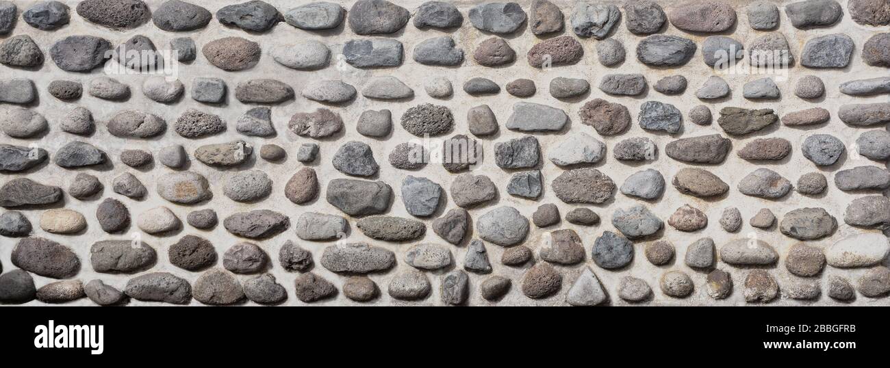 Pebble stone wall texture background. Cement plaster wall decorated by ...