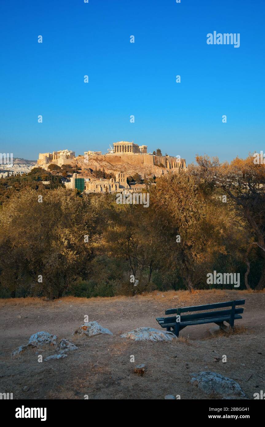 Acropolis historical ruins on top of mountain and bench in Athens ...