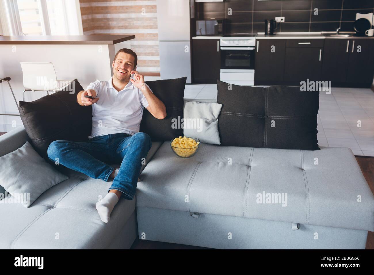 Man alone watching tv talking hi-res stock photography and images - Alamy