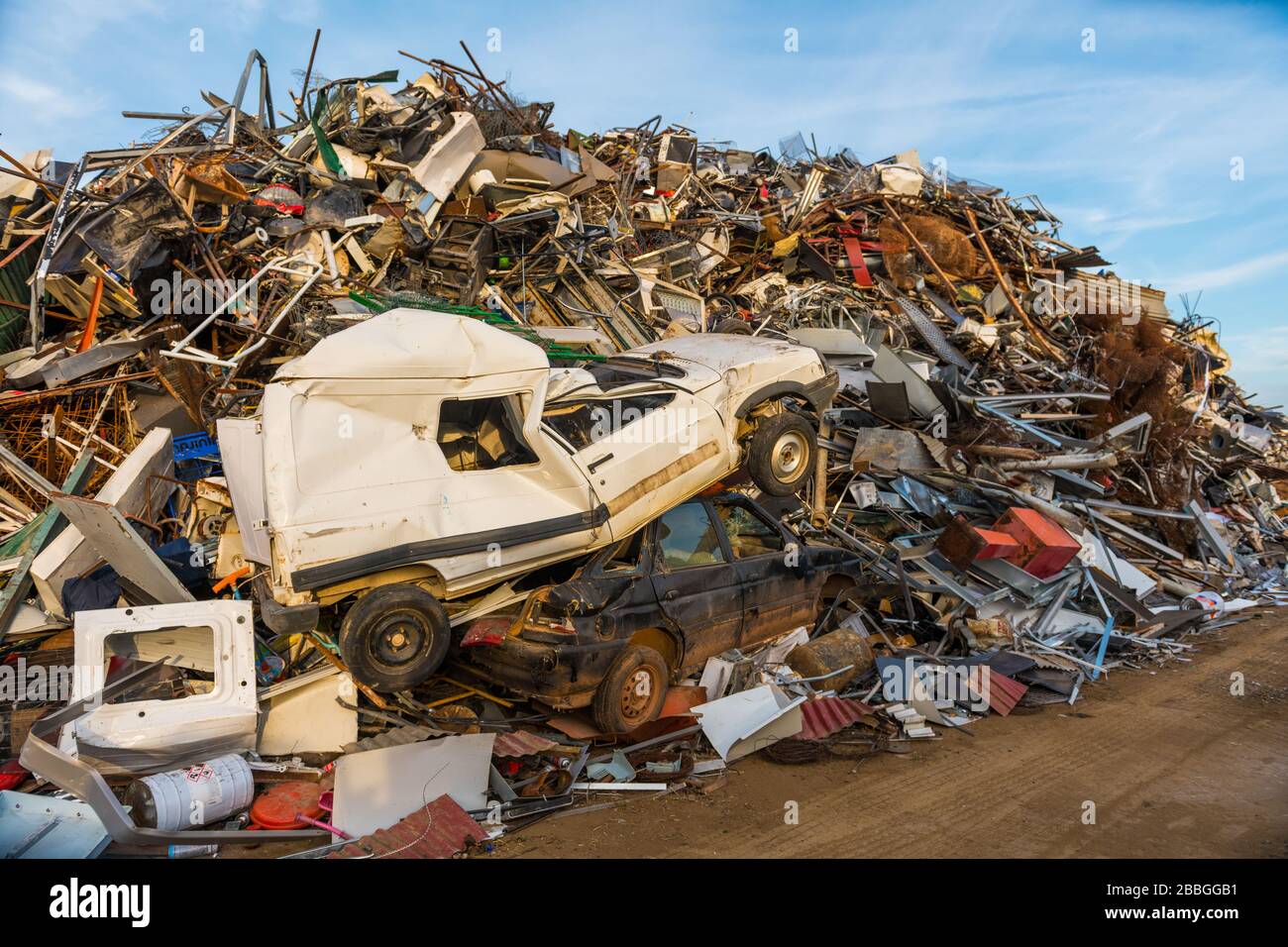 Huge mountain of mainly metal garbage , appliances and a pair of cars ...