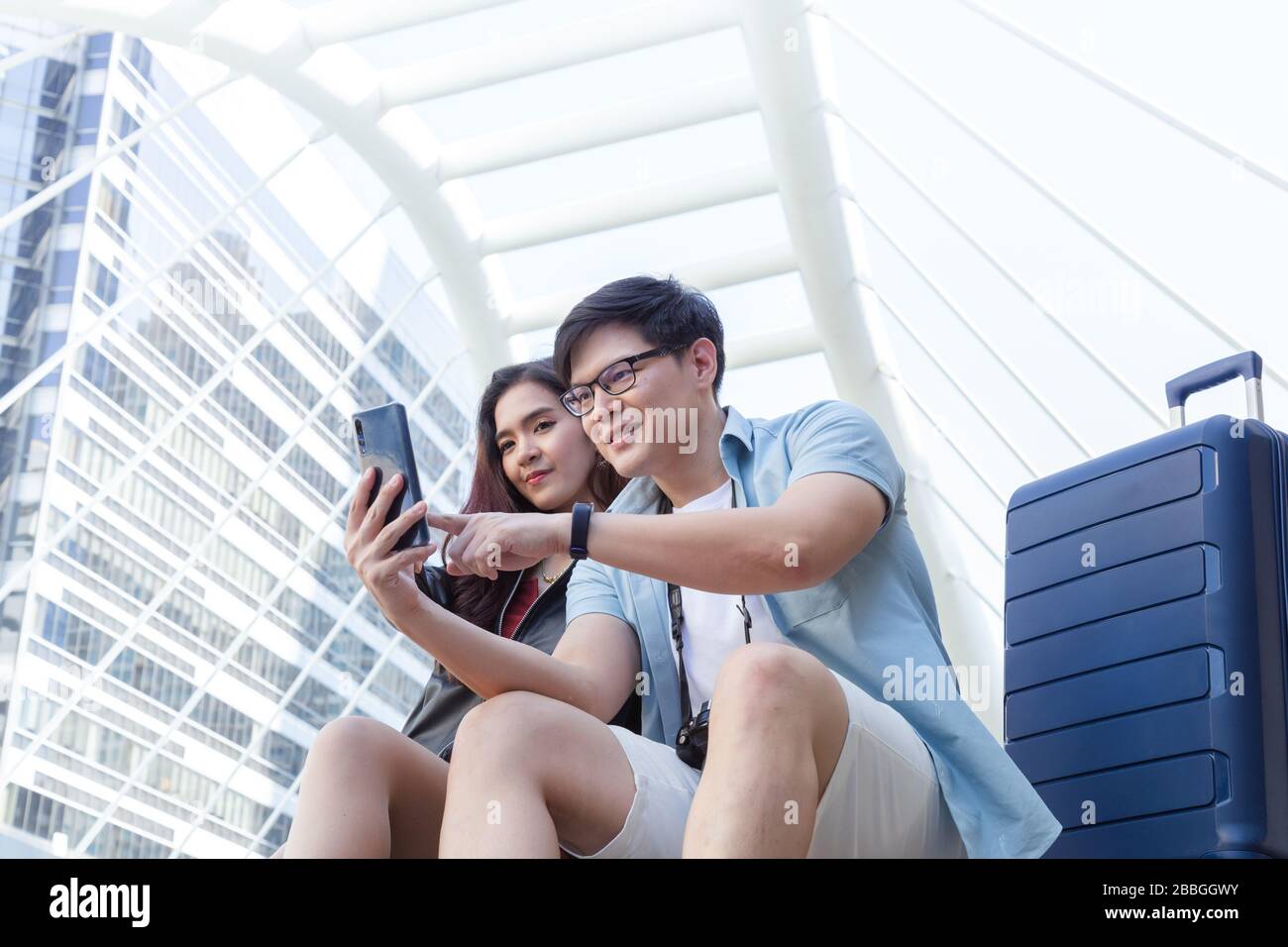 young asian man and woman couple lover traveler using smartphone or ...