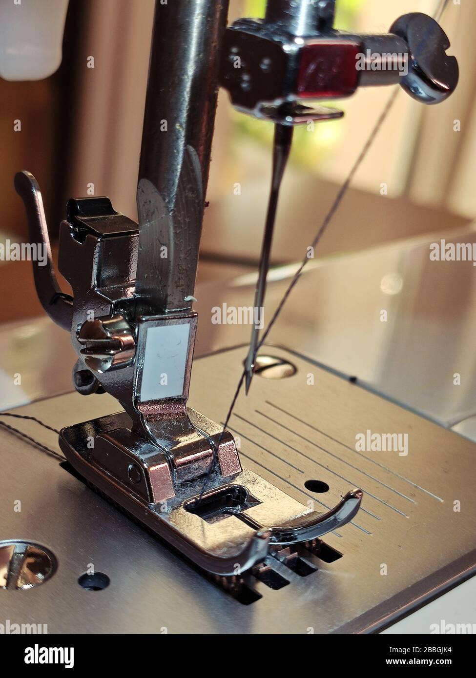 Close-up shot of needle and thread of modern sewing machine Stock Photo ...