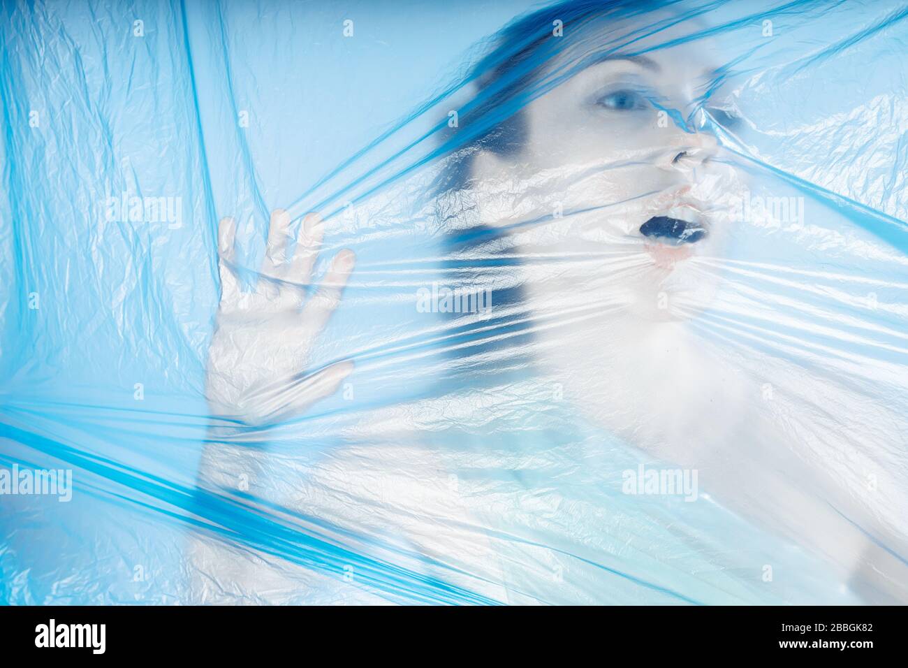 The girl presses her face against the package. The blue bag folded. The ...