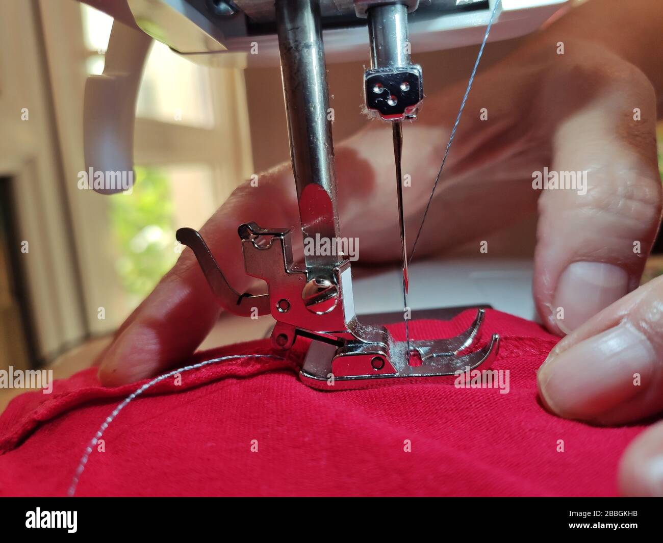 Close-up shot of needle and thread of modern sewing machine Stock Photo ...