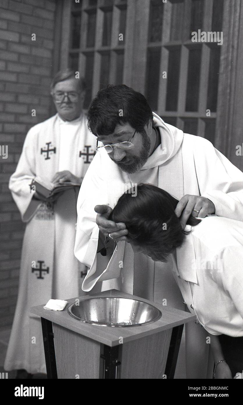 1970s, historical, Inside a church, a woman getting baptised, as a ...