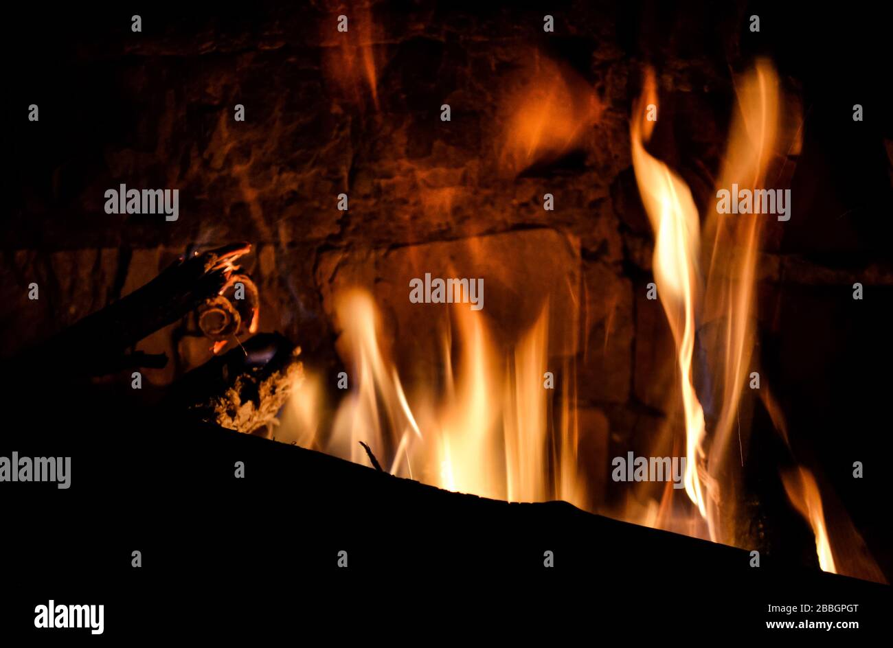 Closeup photo of blazing and warming fireplace in the cold evening ...