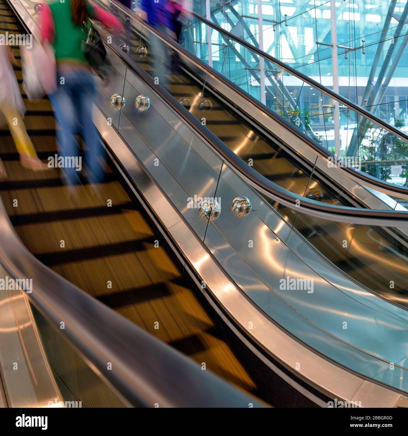 Blurry people moving at automatic stairway Stock Photo - Alamy