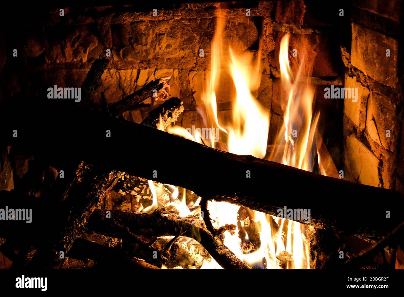 Closeup photo of blazing and warming fireplace in the cold evening ...