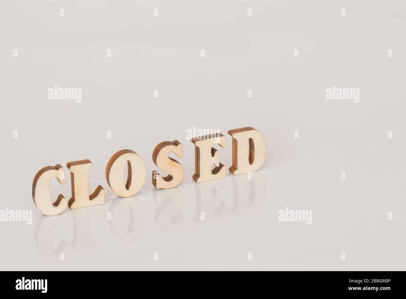 The inscription is Closed with wooden letters on a white background ...