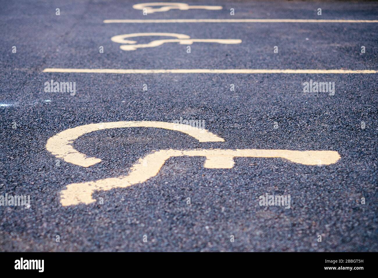 Disable parking spaces in a community centre car park Stock Photo - Alamy