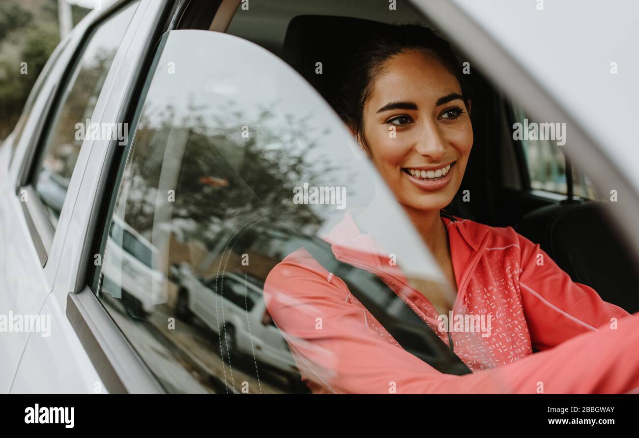Woman driving her car. Smiling female driving her vehicle Stock Photo ...