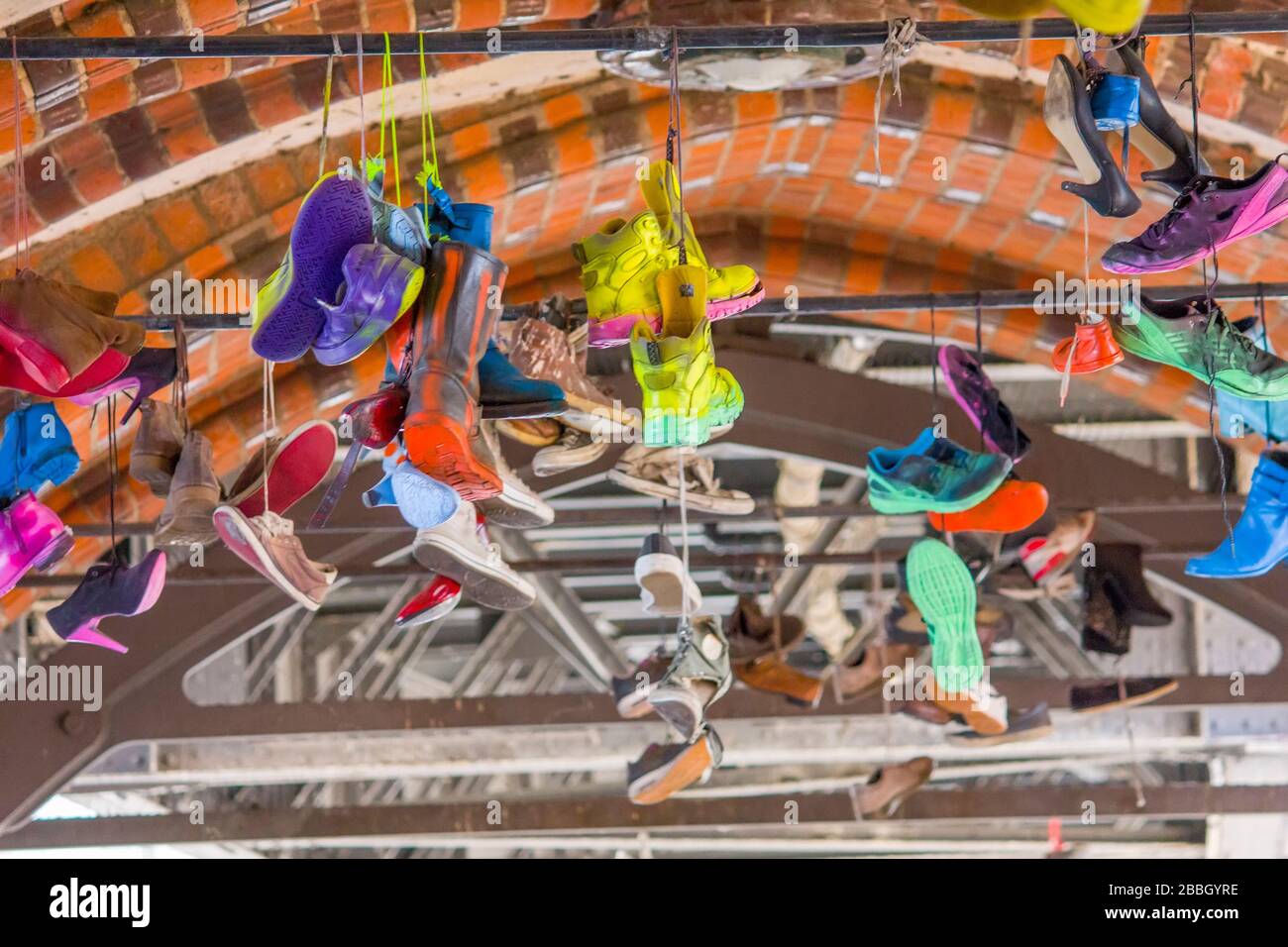 Old colorful shoes hanging on the bridge in Berlin Stock Photo - Alamy