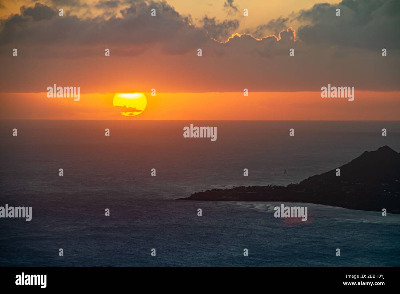 A sunset over the Hawaiian Island of Oahu as seen from a mountain top ...