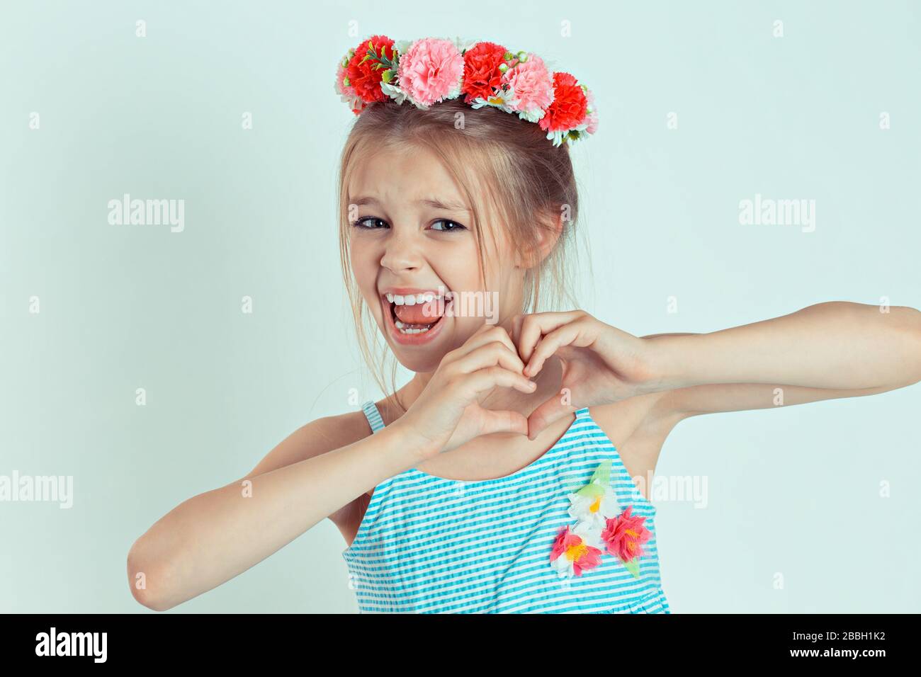 Closeup euphoric screaming cheerful happy young girl kid making heart ...