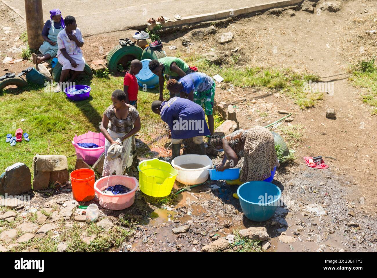 Kenyan women washing clothes outdoors in plastic containers, Nairobi ...