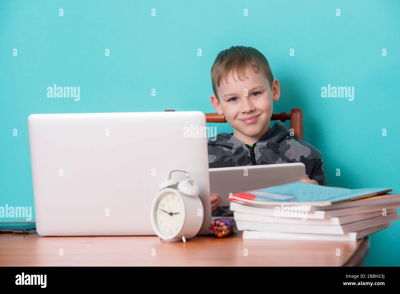 School kid using laptop while doing schoolwork at home. Homeschooling ...