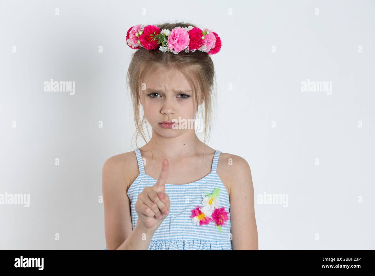 kid gesturing a no sign. portrait unhappy, serious child girl raising ...