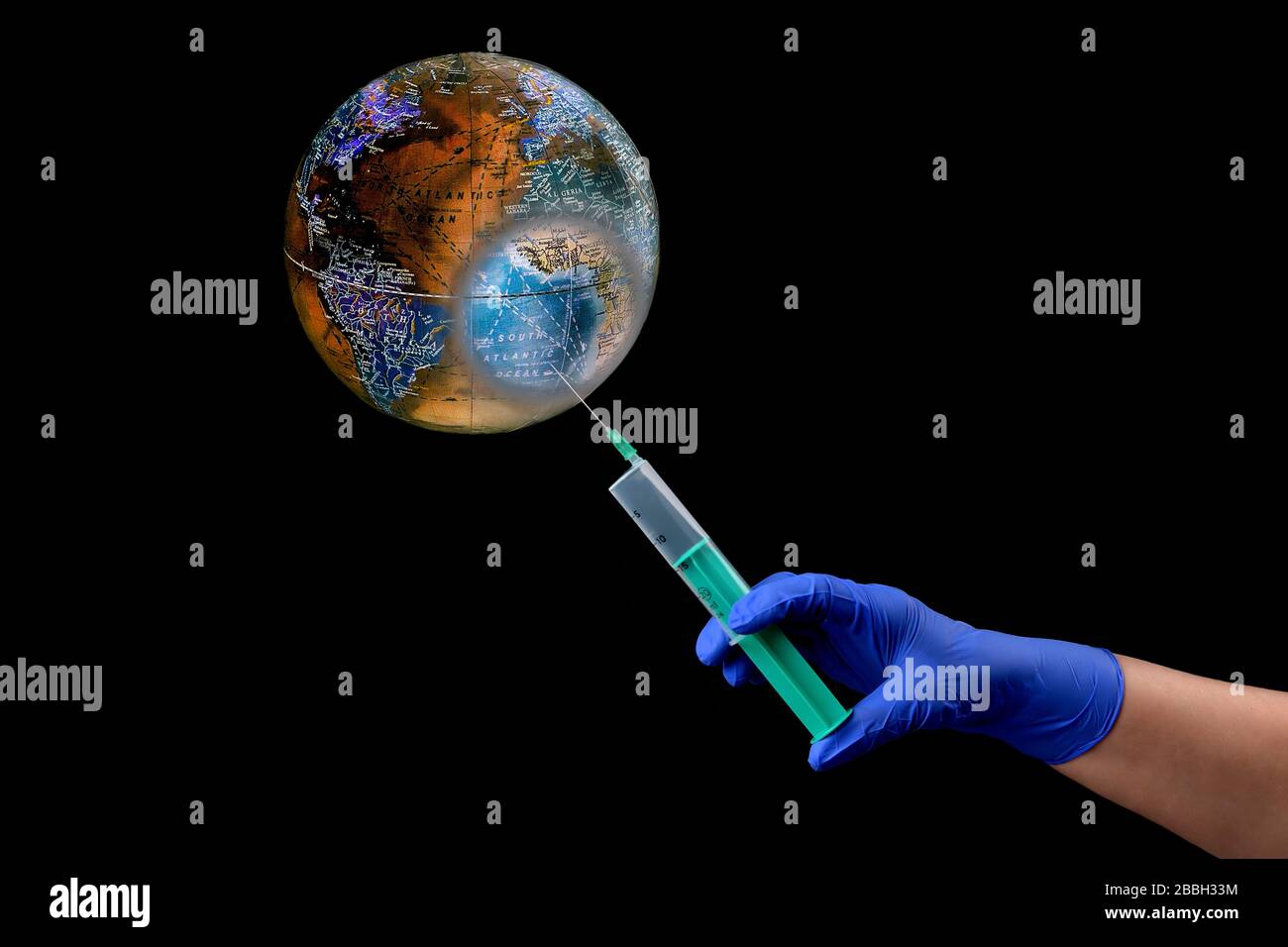 Planet earth infected with a virus, a hand in a medical glove with a ...