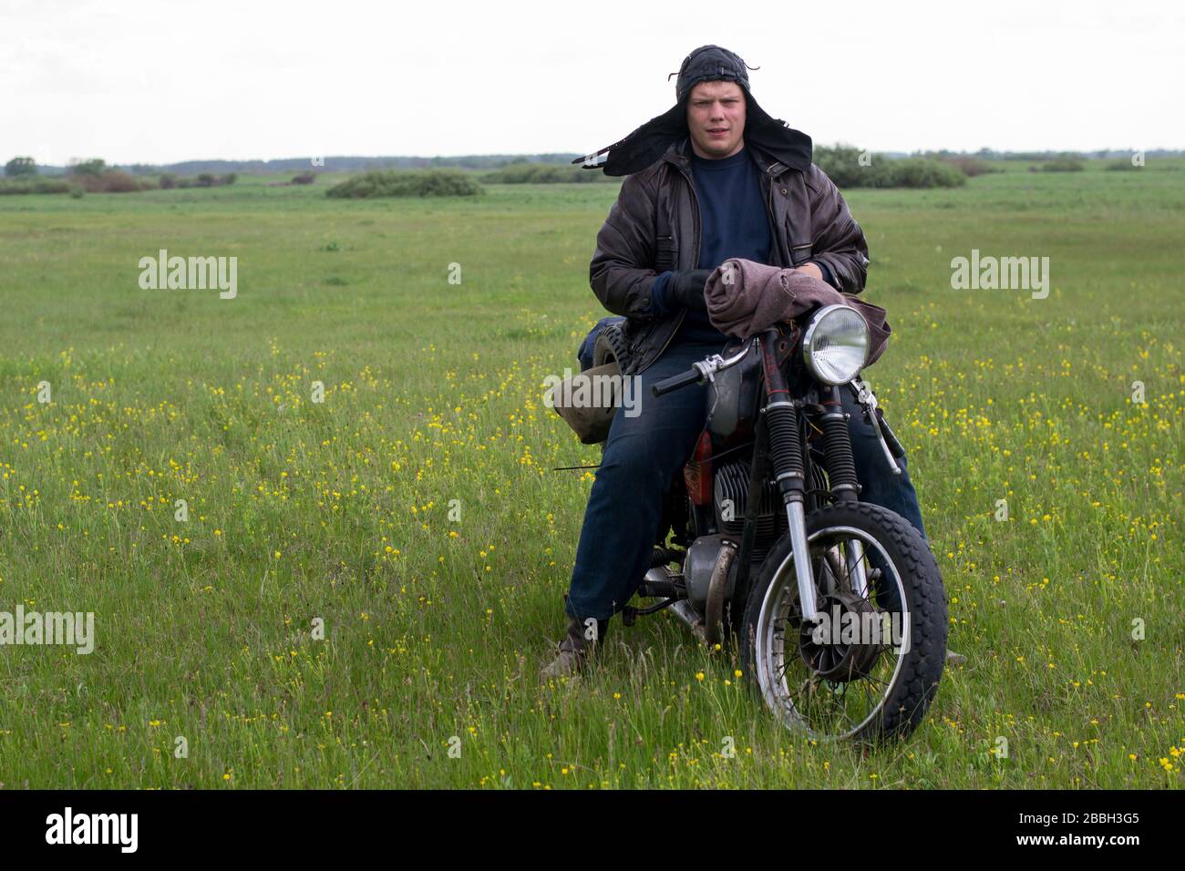A post apocalyptic man on motorcycle in meadow Stock Photo - Alamy