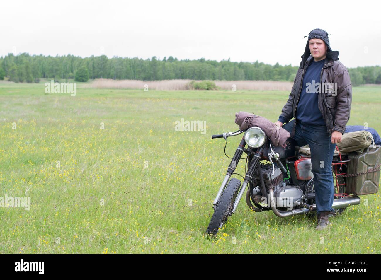 A post apocalyptic man on motorcycle in meadow Stock Photo - Alamy