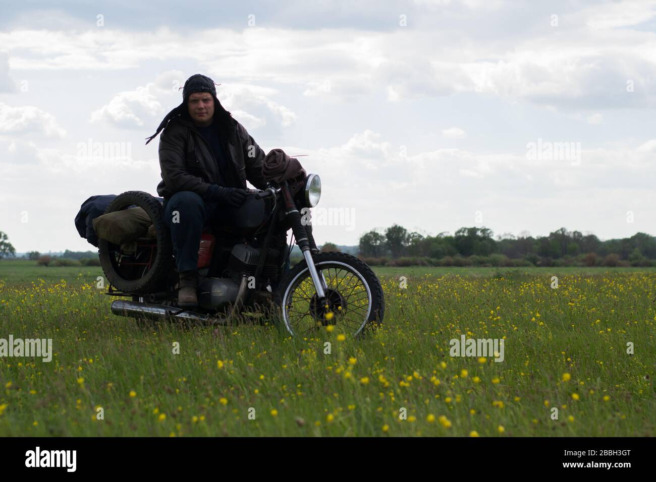 A post apocalyptic man on motorcycle in meadow Stock Photo - Alamy