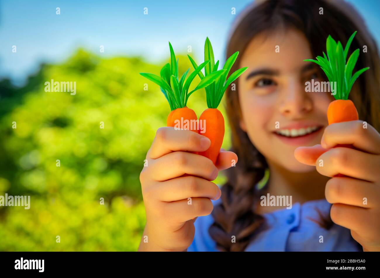 Little girl with carrots, kids on a healthy vegetarian diet, selective ...