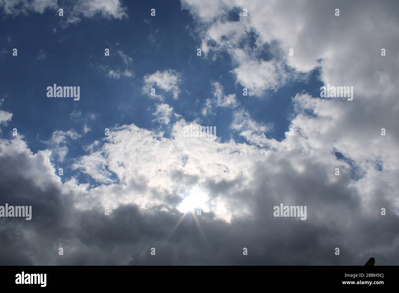 Spring Cloudy Sky with sun Stock Photo - Alamy