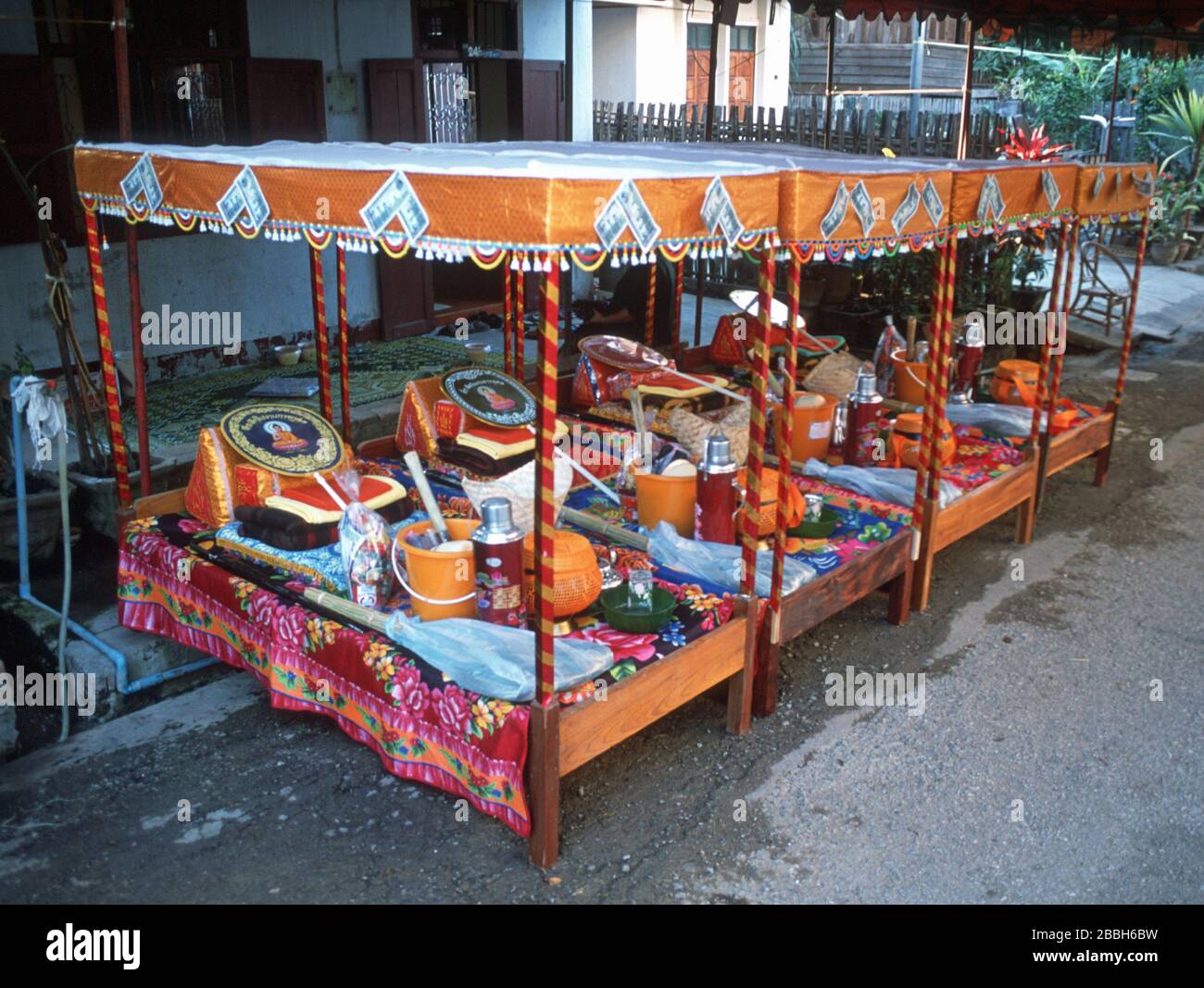 Elaborate, ornamental beds, lined up on a street in Luang Prabang, Laos ...