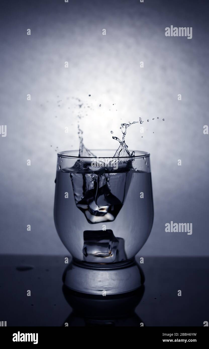 splashing from a glass when throwing ice cubes, vignetting Stock Photo ...
