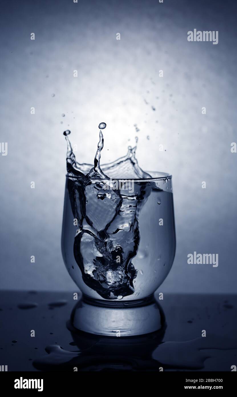 splashing from a glass when throwing ice cubes, vignetting Stock Photo ...