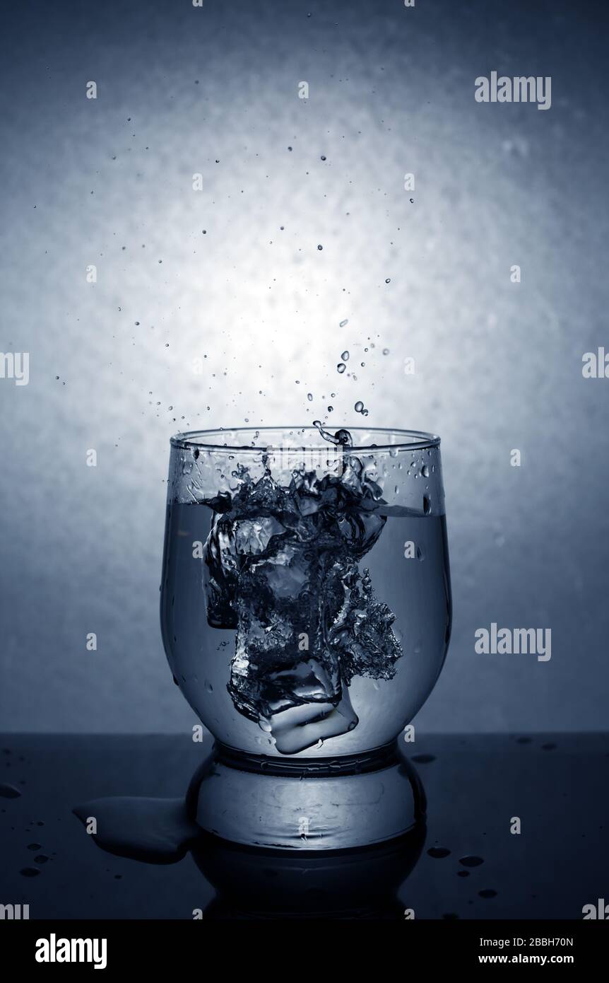 splashing from a glass when throwing ice cubes, vignetting Stock Photo ...