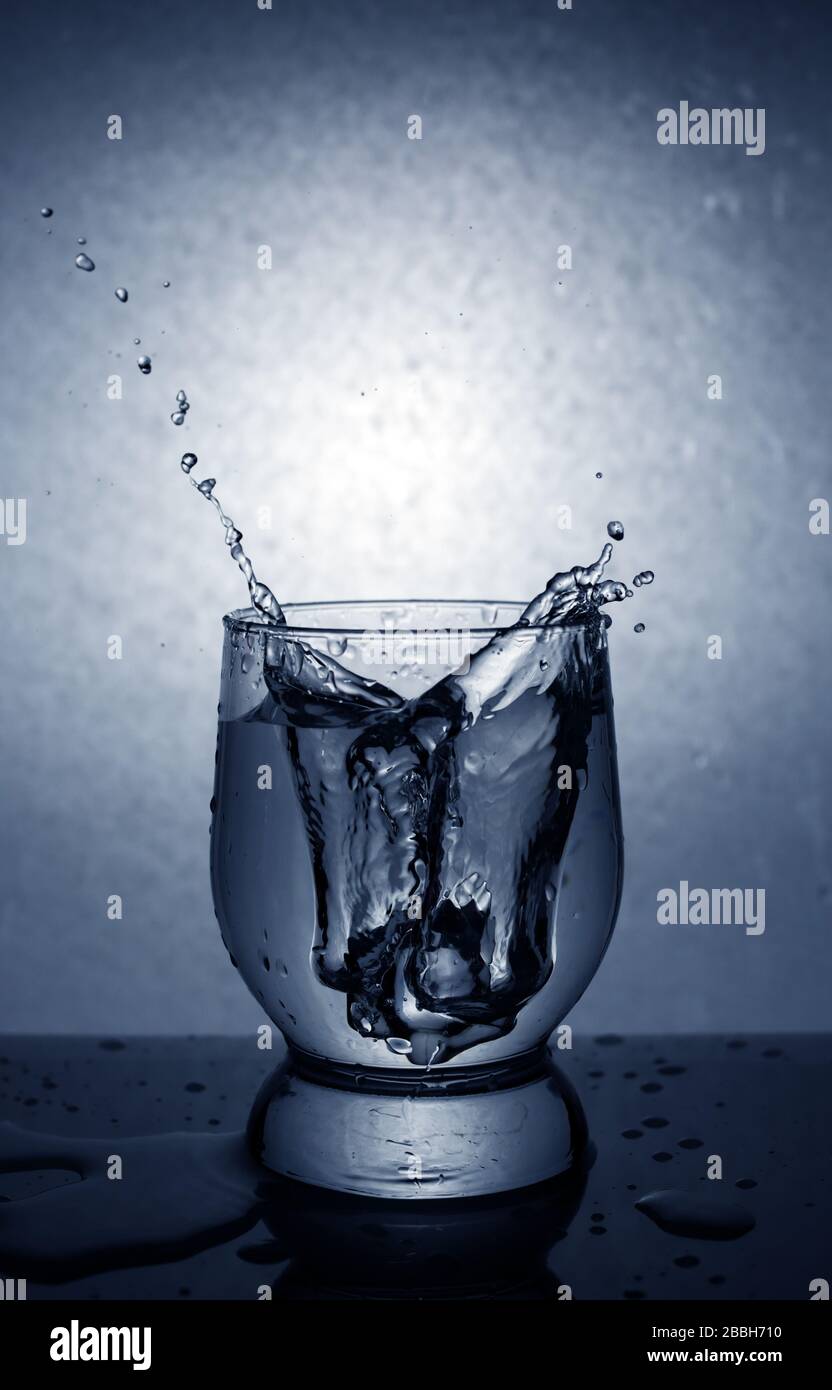 splashing from a glass when throwing ice cubes, vignetting Stock Photo ...