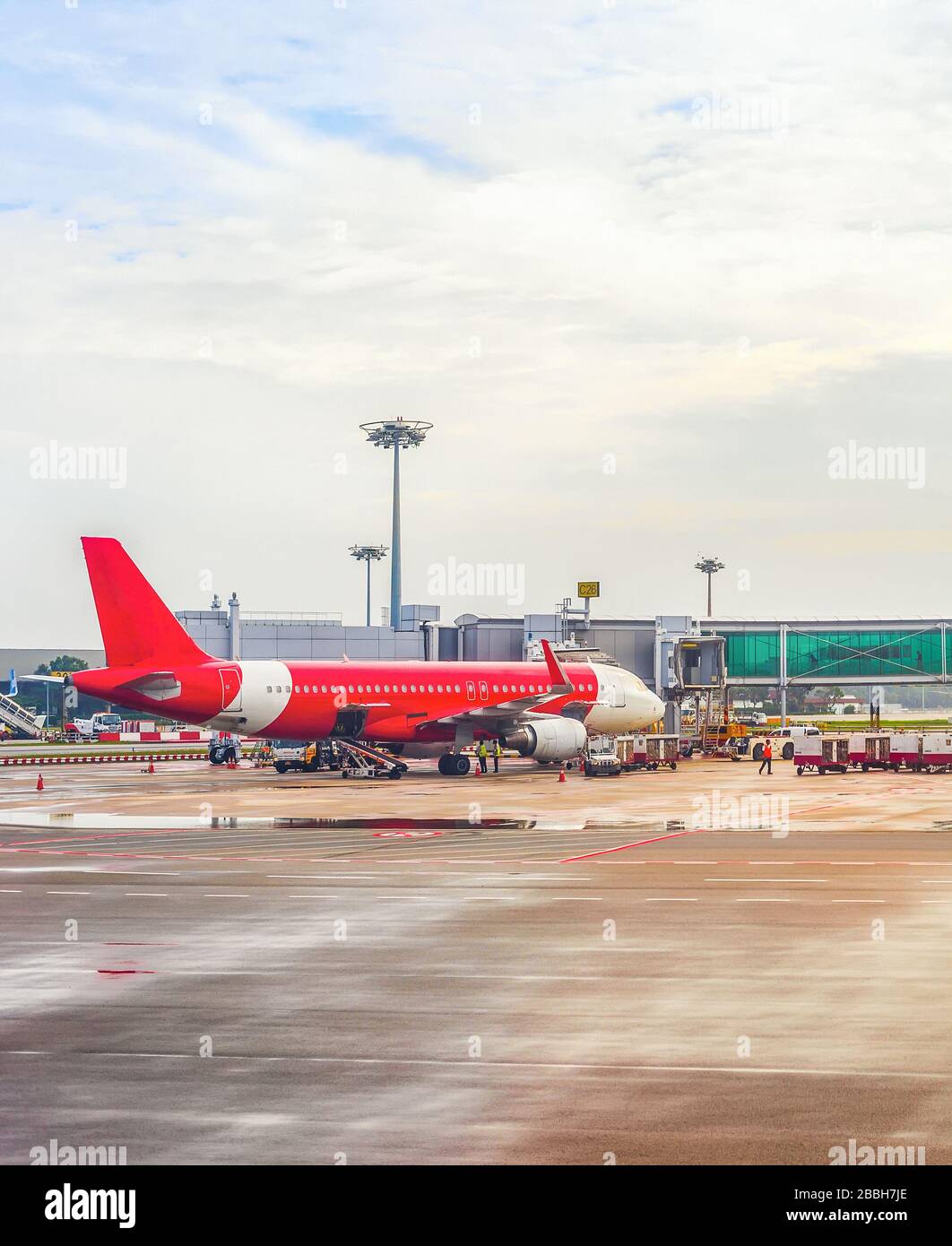 Red plane at airfield by airport terminal, maintenance, flying airplane ...