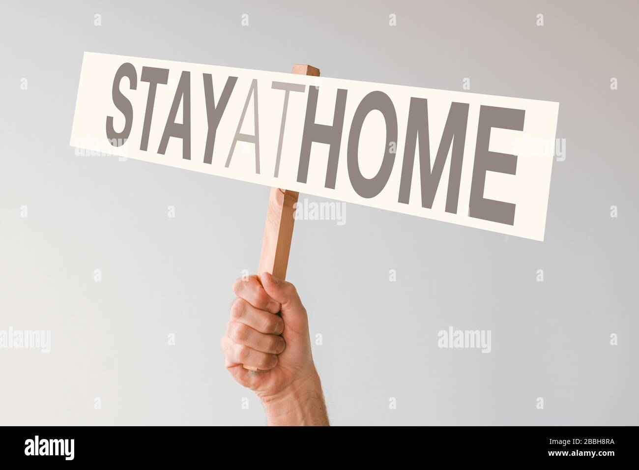 Stay at home concept, male hand holding protesting banner Stock Photo ...