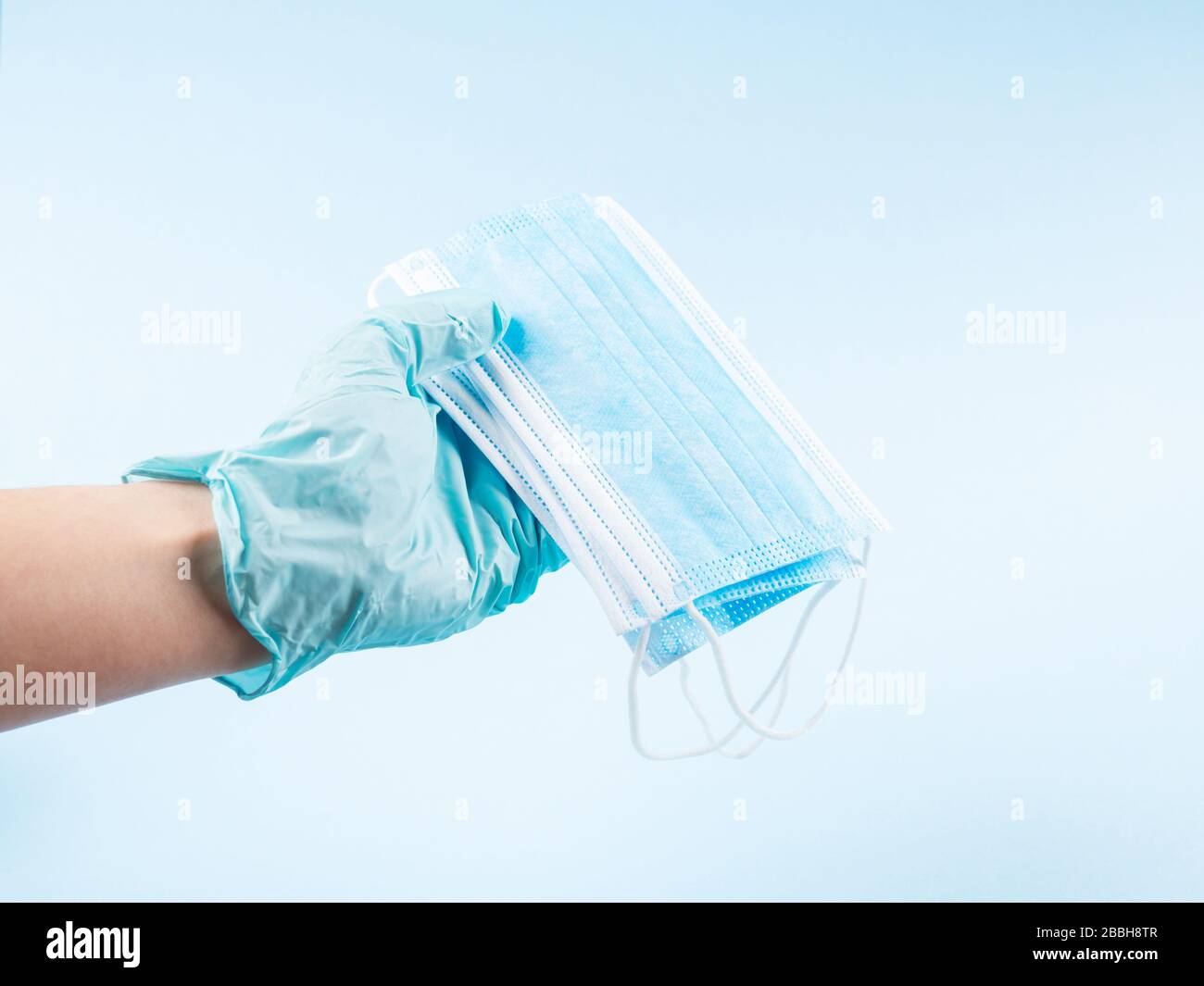 Face masks on blue as symbol of covid19 pandemic Stock Photo - Alamy