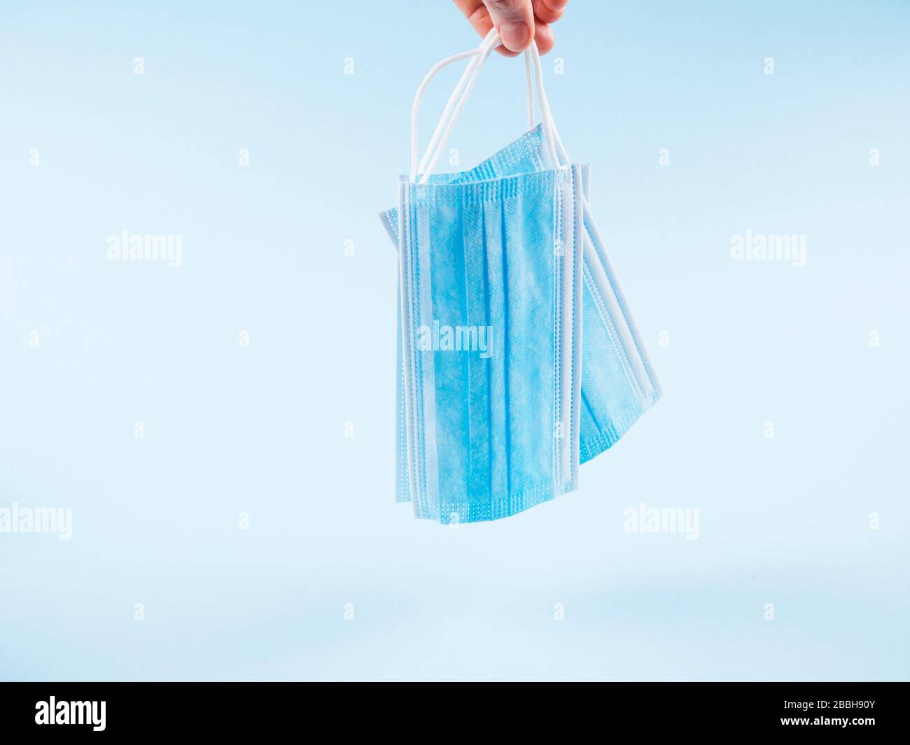 Face masks on blue as symbol of covid19 pandemic Stock Photo - Alamy