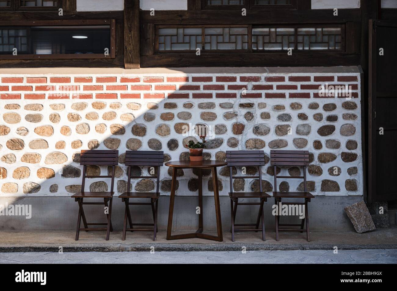 Wooden table and chairs on brick wall in traditional cafe Stock Photo ...