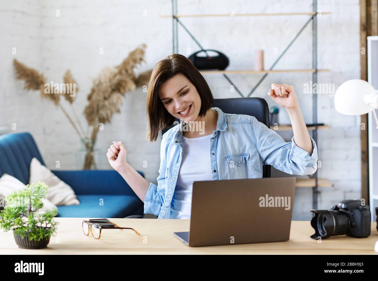 Working from home. Portrait of smiling female freelancer with laptop ...