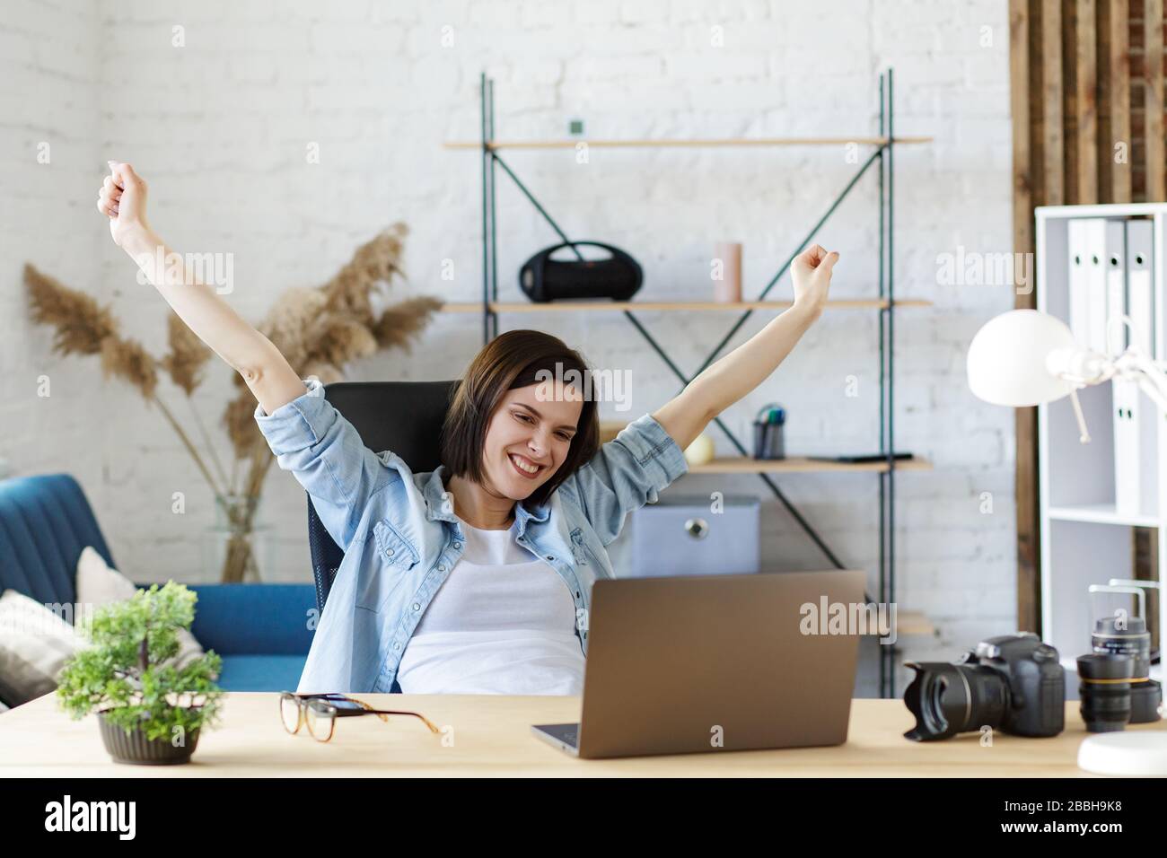 Working from home. Portrait of smiling female freelancer with laptop ...