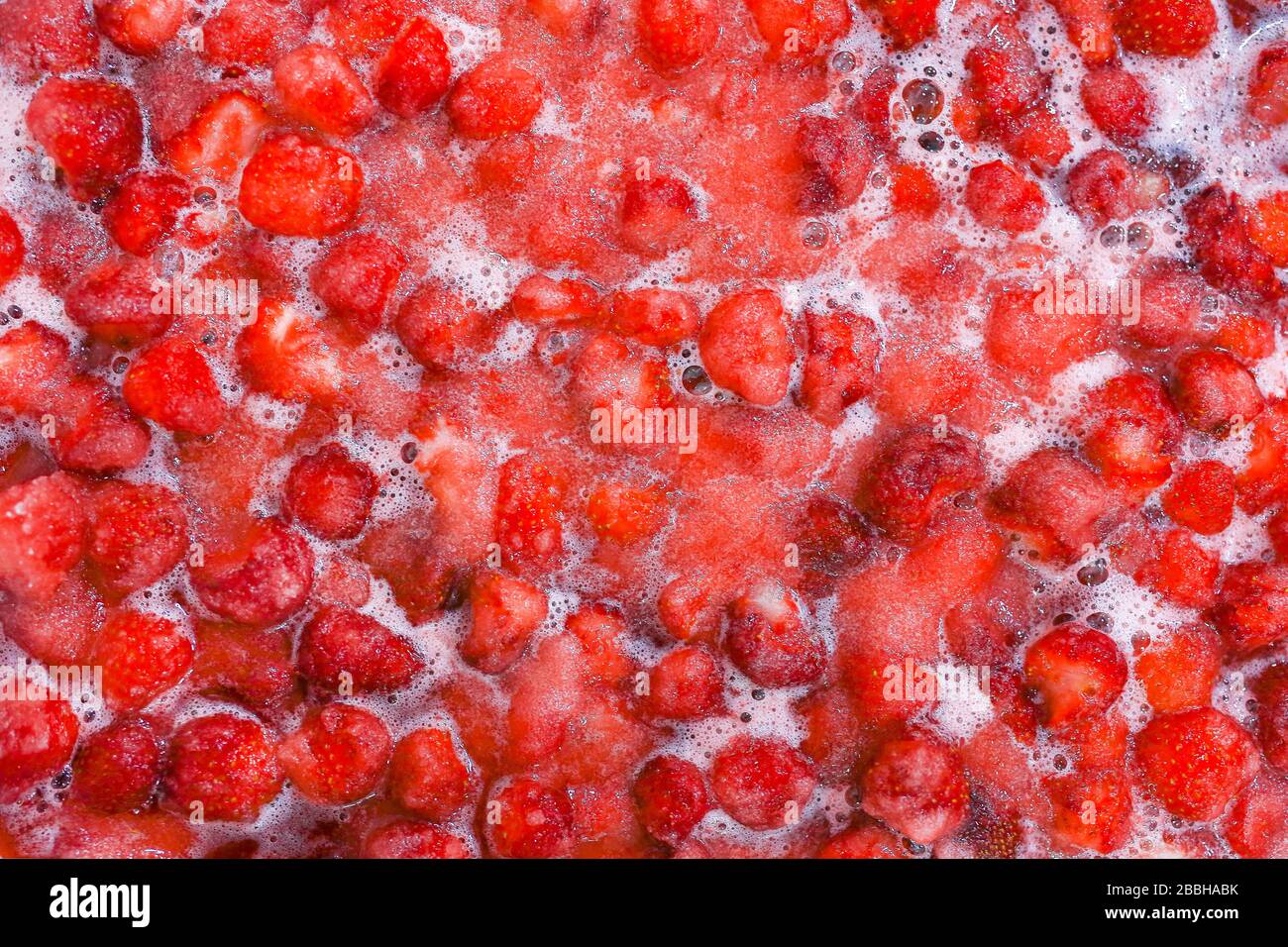Strawberry jam cooking process. Organic traditional jam manufacturing ...